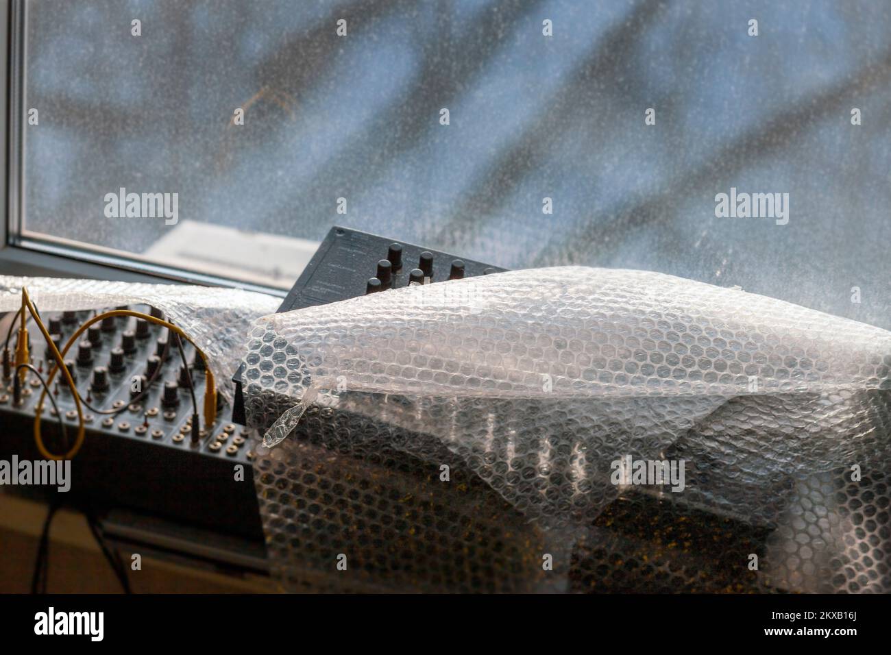 a pile of electronic musical instruments covered with film and ...