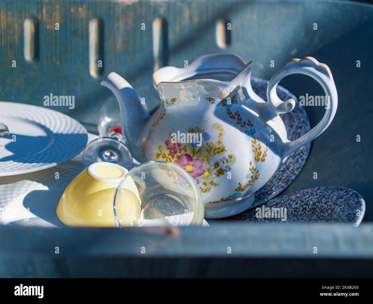 collection of porcelain tableware with a teapot in the center of ...