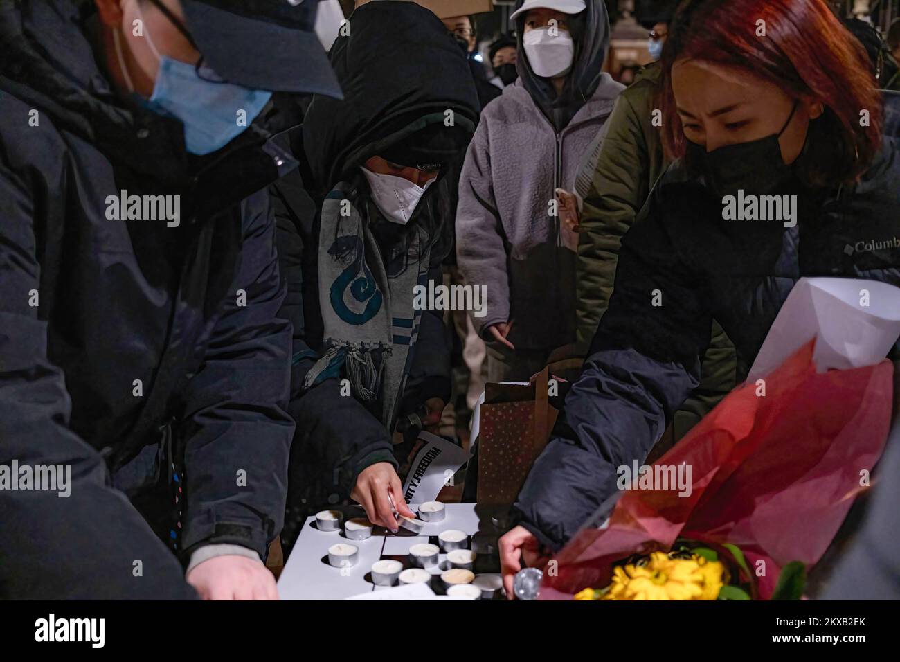 Boston, United States. 29th Nov, 2022. Protesters light candles and ...