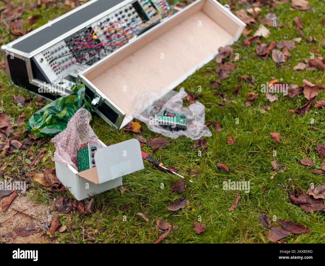 assembling modular synthesiser dropped on the ground for performance or ...