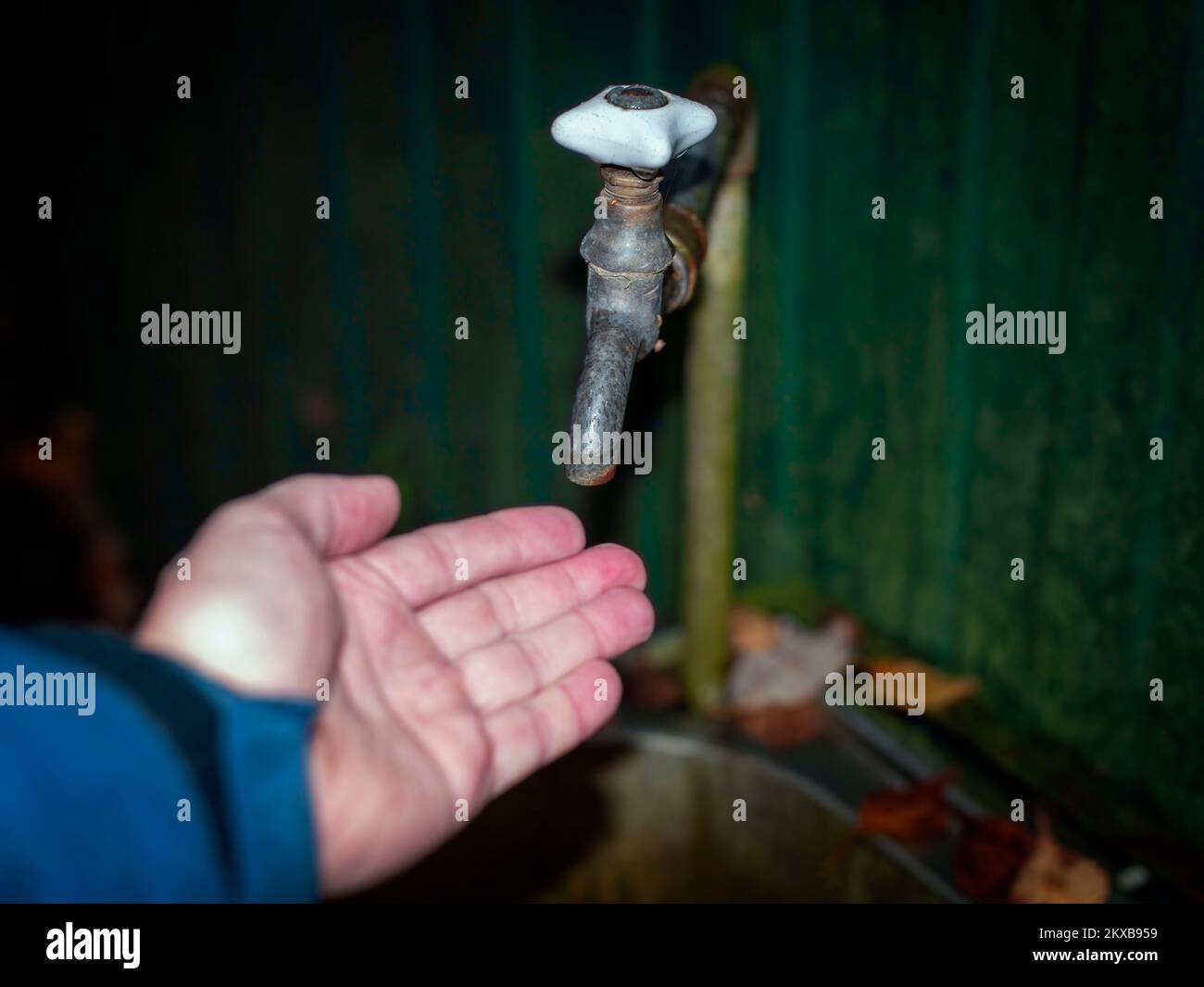 a male hand close to a water tap, outdoor shot, human disaster concept ...