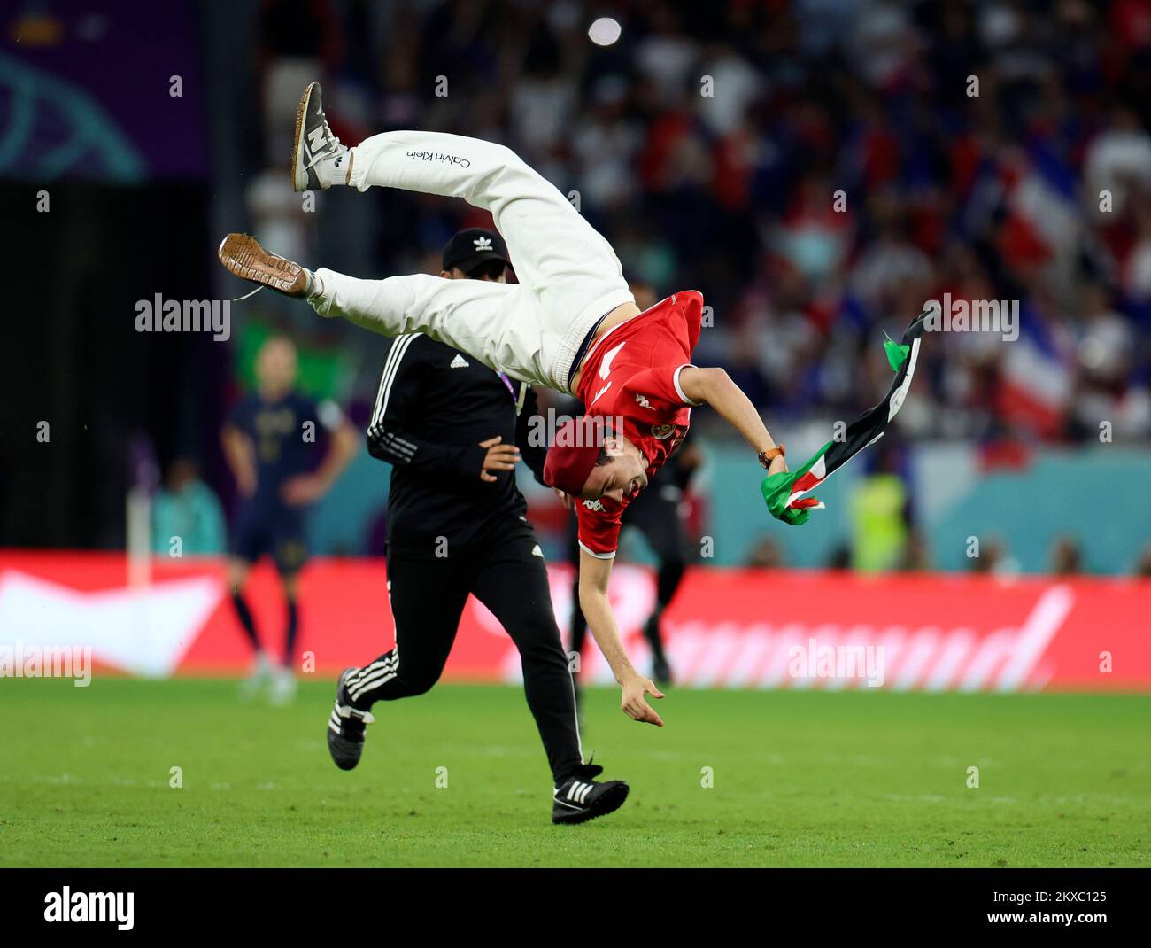Al Rayyan, Qatar. 30th Nov, 2022. A pitch invader does a flip flop ...