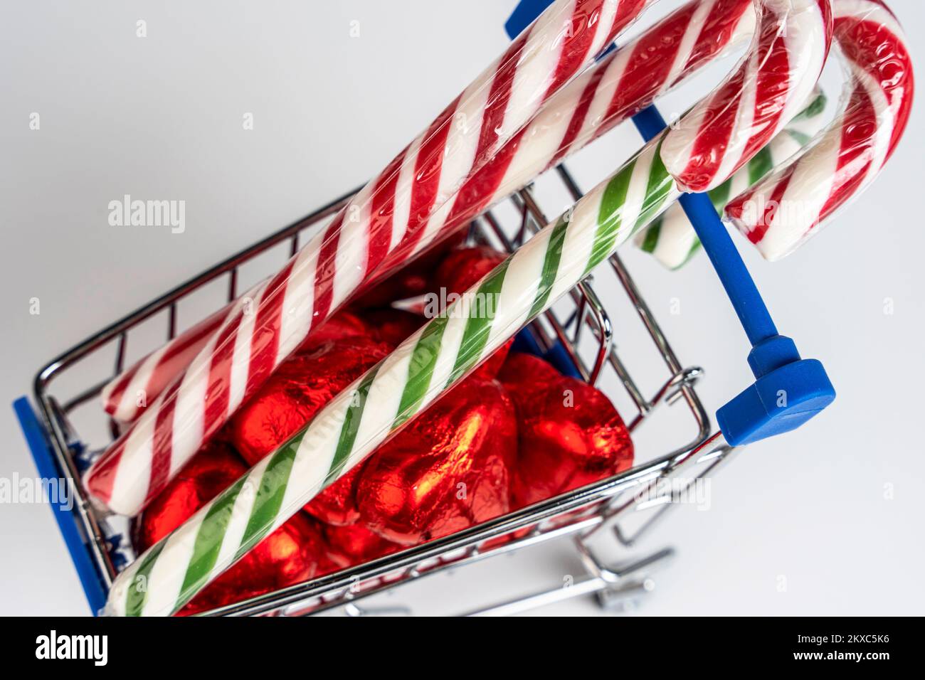 A supermarket trolley loaded with candies and Christmas caramel canes ...