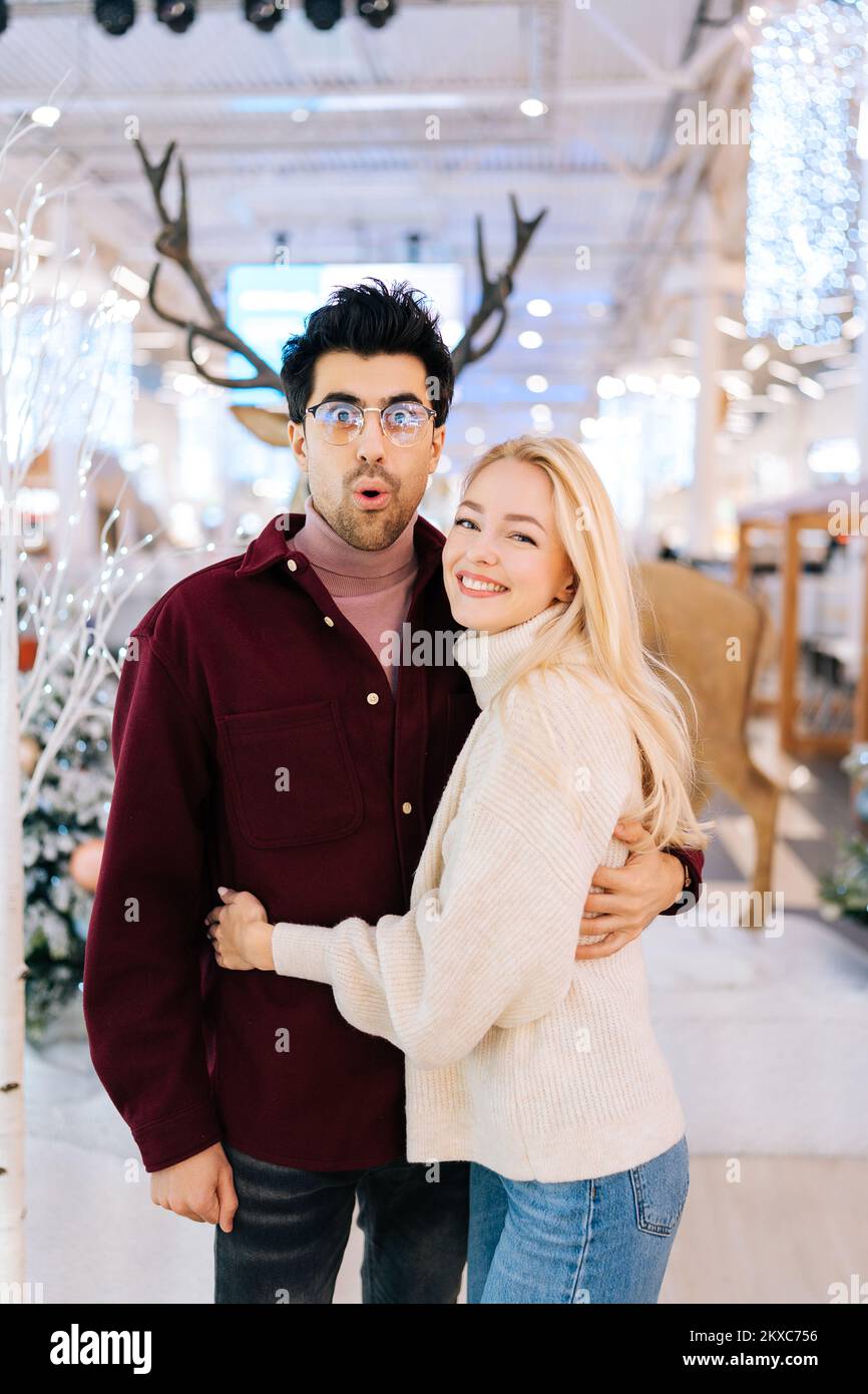 Vertical portrait of cheating wife with husband with deer antlers ...