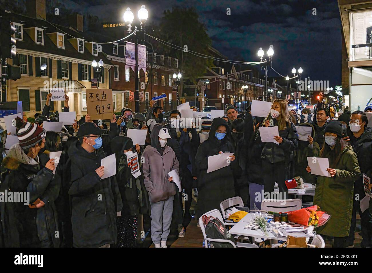 Protesters hold blank papers and placards during a demonstration ...
