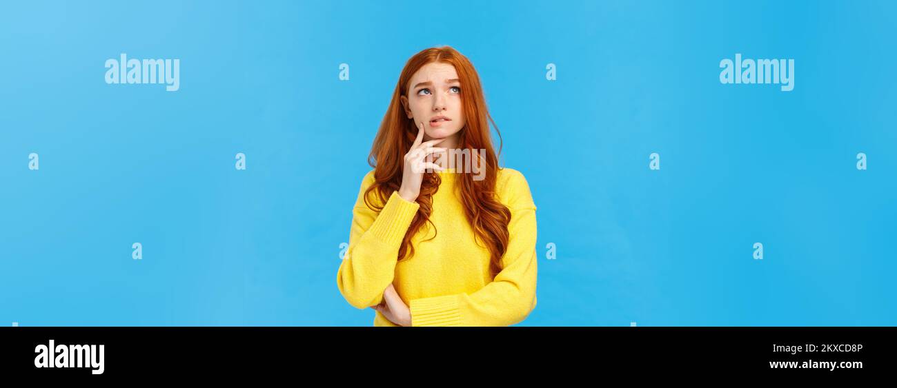 Perplexed, worried and concerned cute redhead student college girl ...