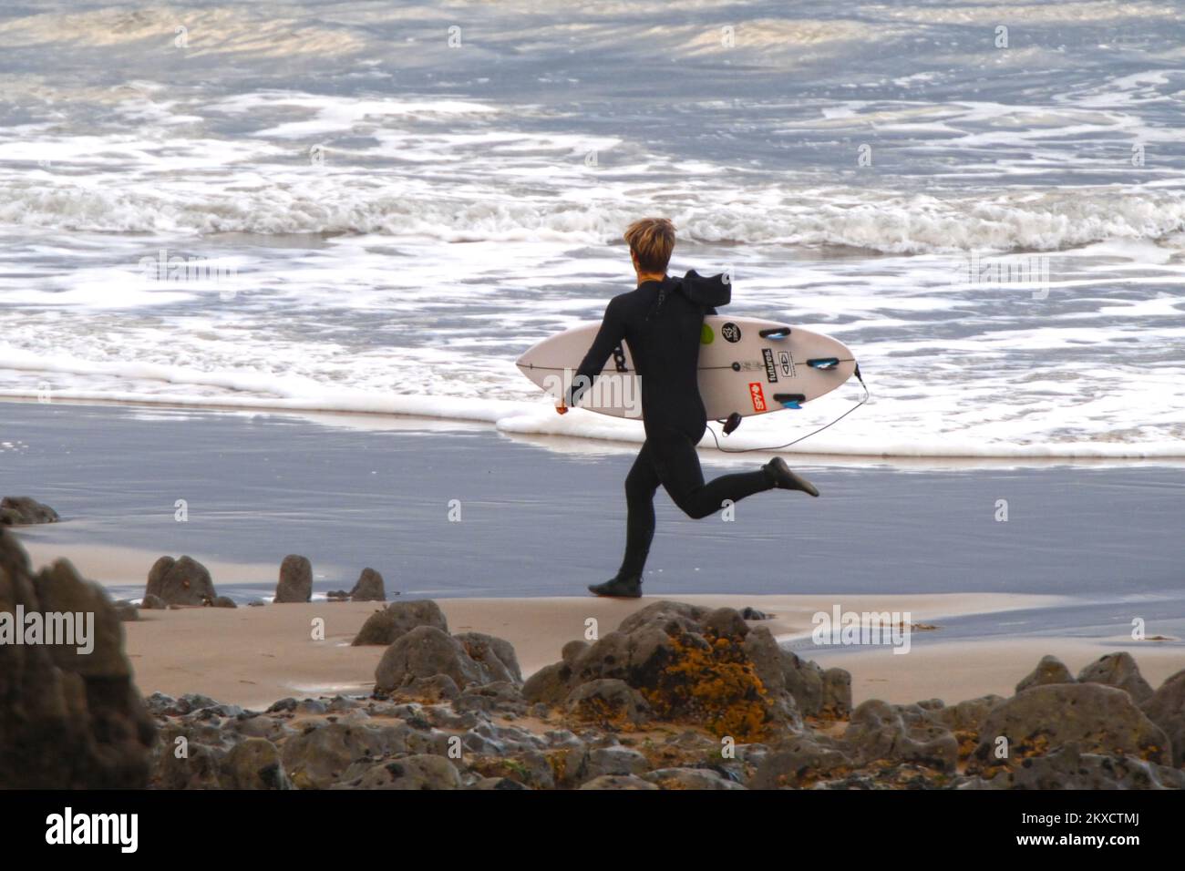 Top surfer Patrick Langdon-Dark runs across the beach to the surf ...