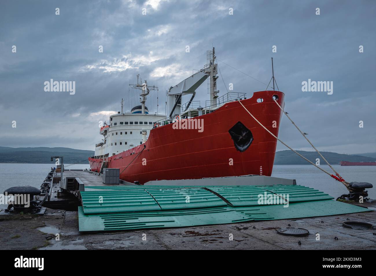 Gloomy image of a passenger ship came to anchor in harbor. Murmansk ...