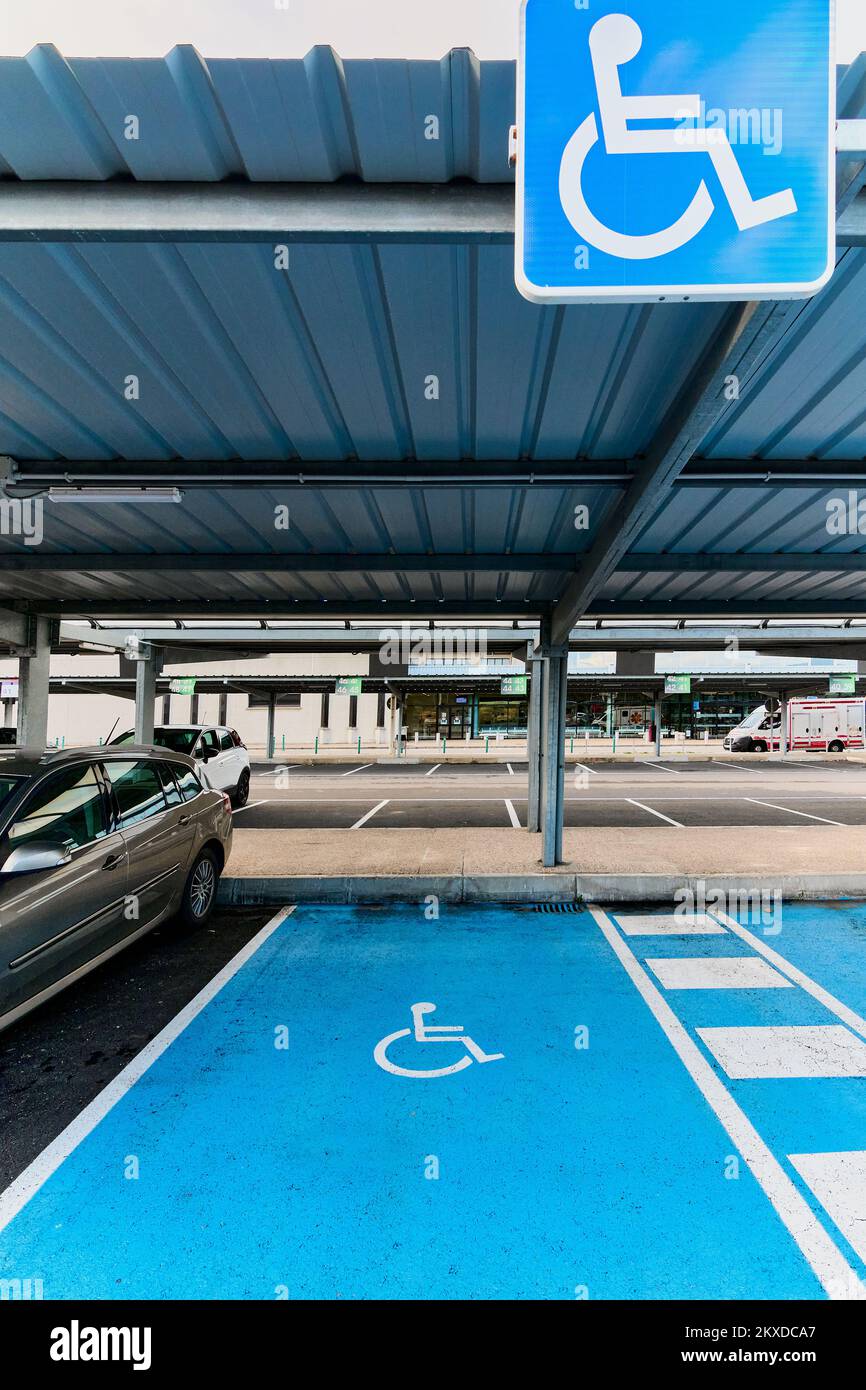 Free parking space reserved for the disabled on blue asphalt with the ...
