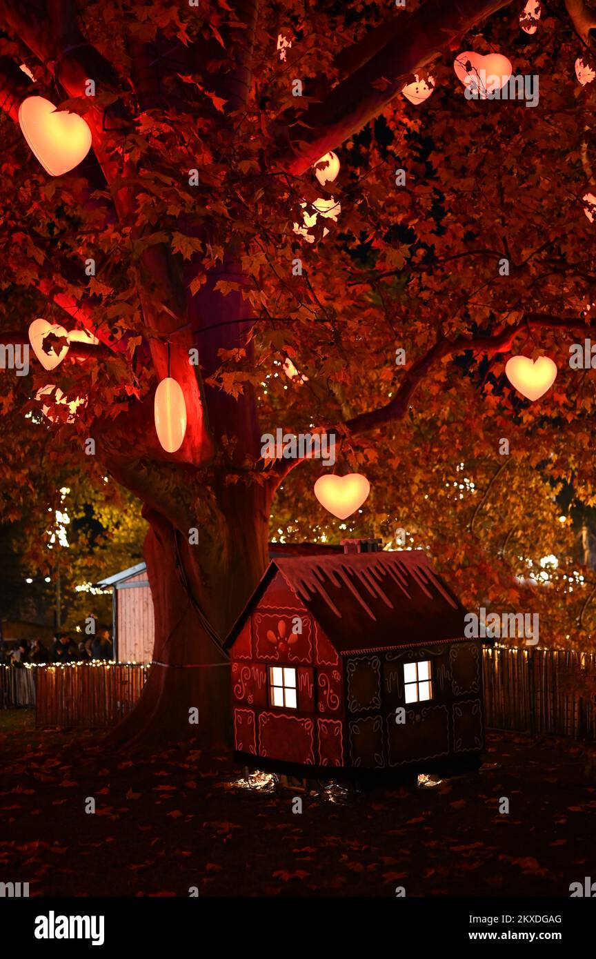 Illuminated tree with heart shaped lights and little house on Christmas ...