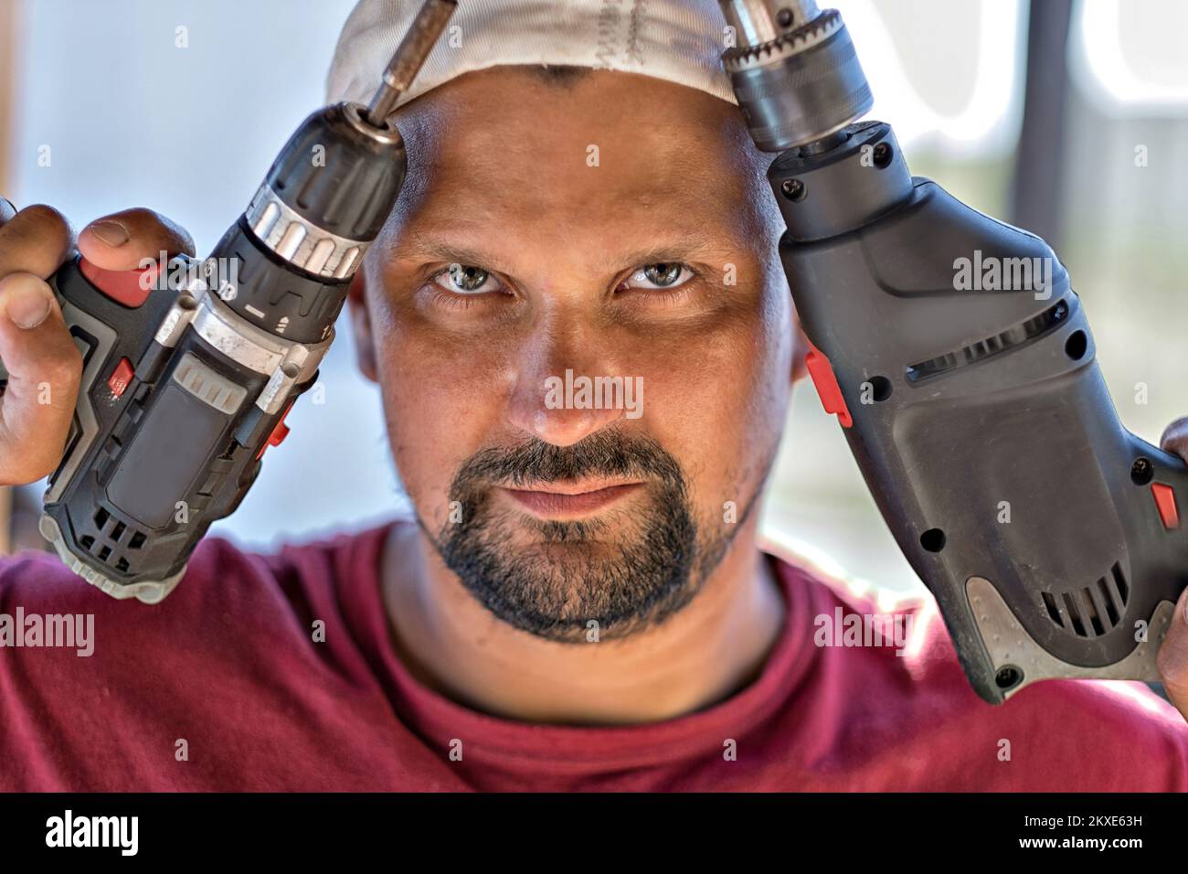 Male swarthy builder at work. Close-up portrait of a worker with a ...
