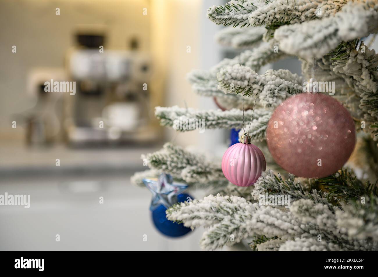 Decorated Christmas tree branch at blurred kitchen background Stock ...