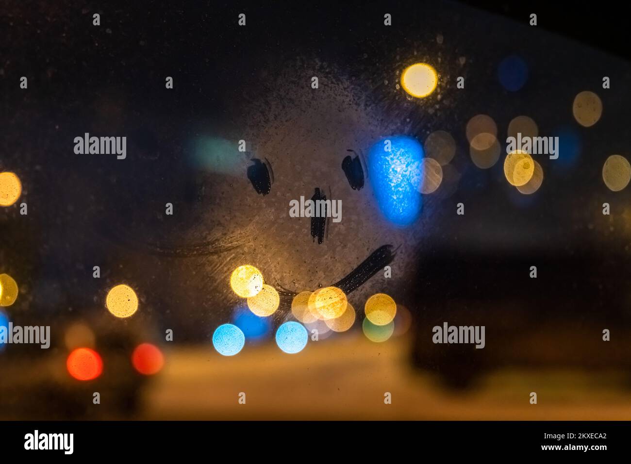 smiling smiley face on glass against the background of lights Stock ...