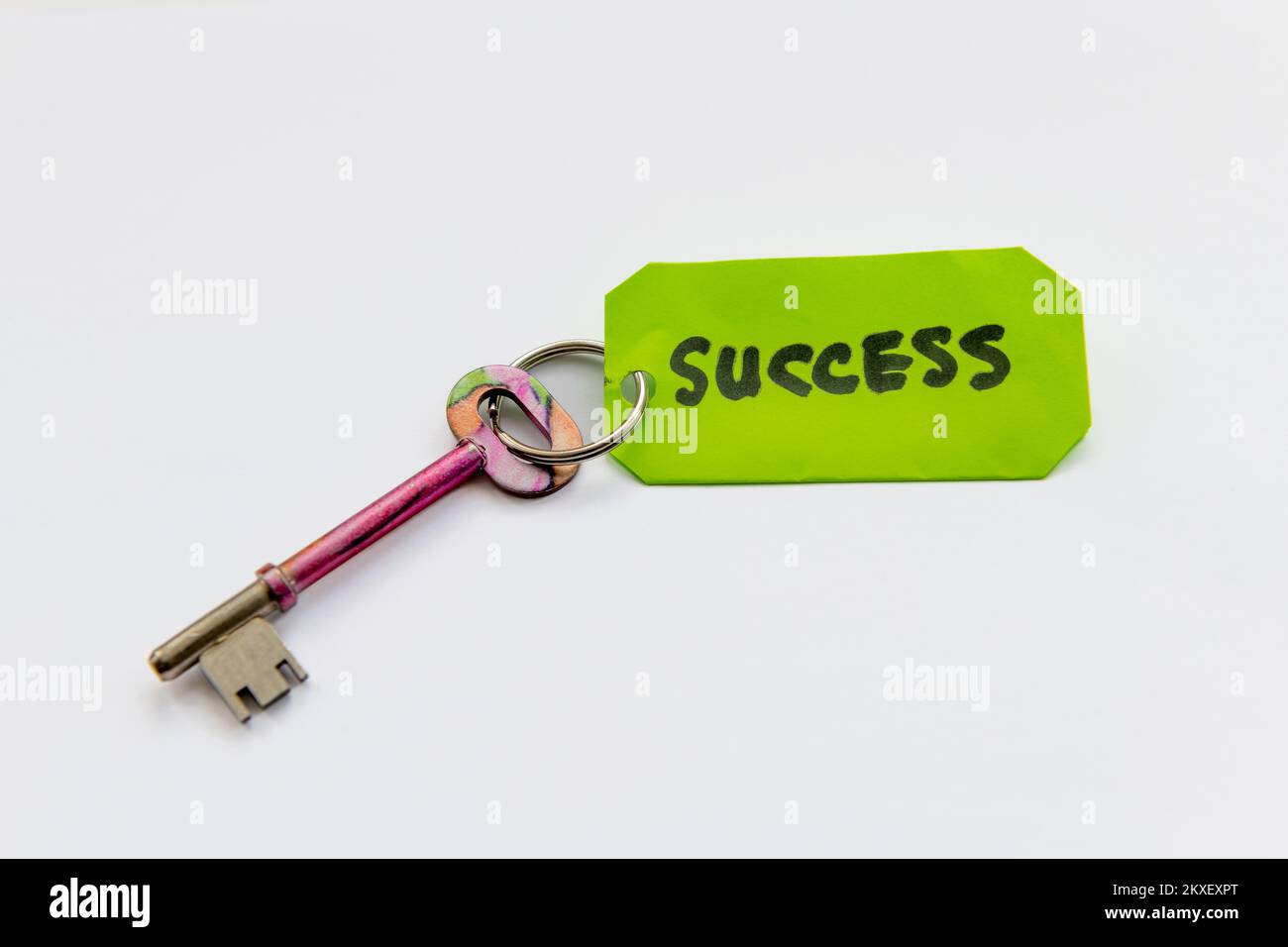 A key to success concept with a key and the word success isolated in ...