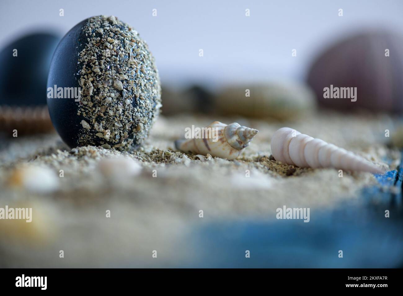 Easter eggs decorated with seashells and sand Stock Photo - Alamy