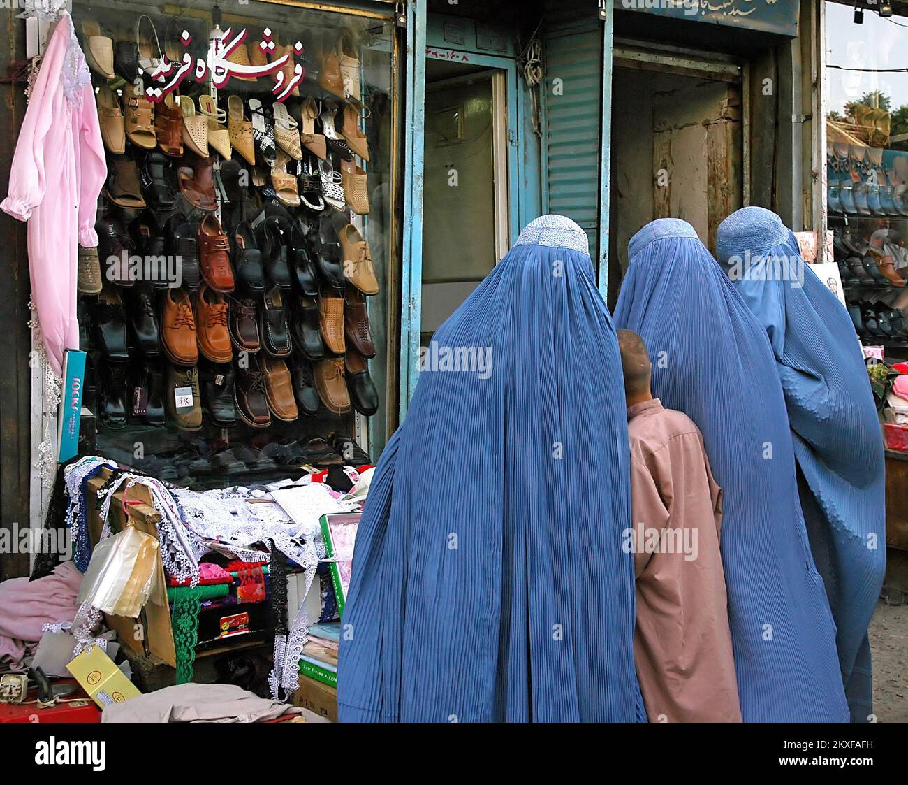 Kabul / Afghanistan: Afghan women standing outside a shoe store in ...