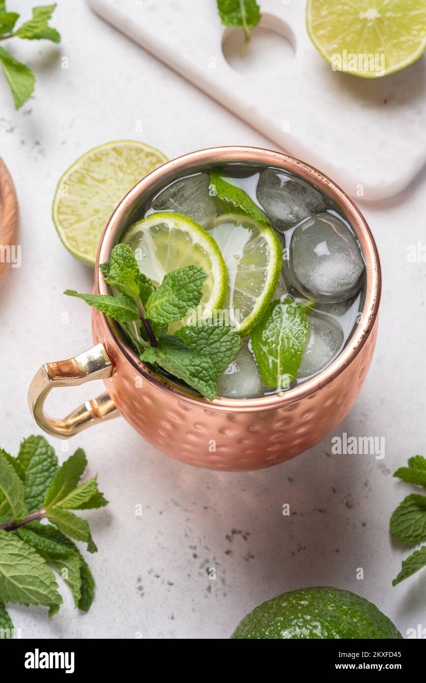 Moscow mule alcoholic cocktail in copper mug with lime, mint and ...