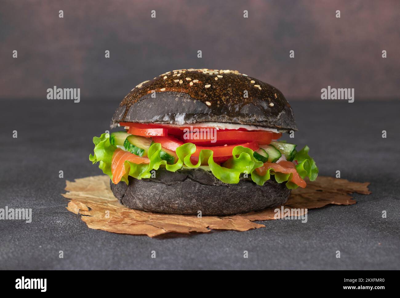 Veggie black burger with salted salmon, crab meat and vegetables on ...