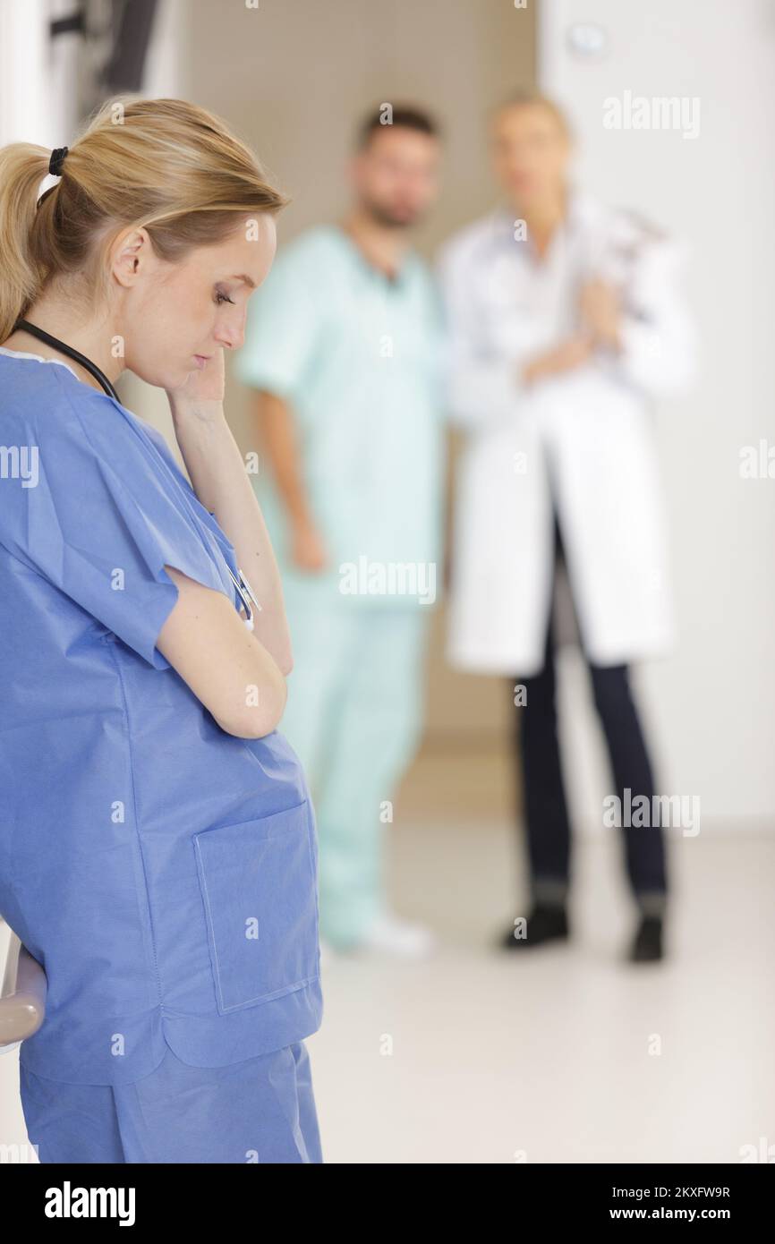 sad female nurse at hospital corridor Stock Photo - Alamy