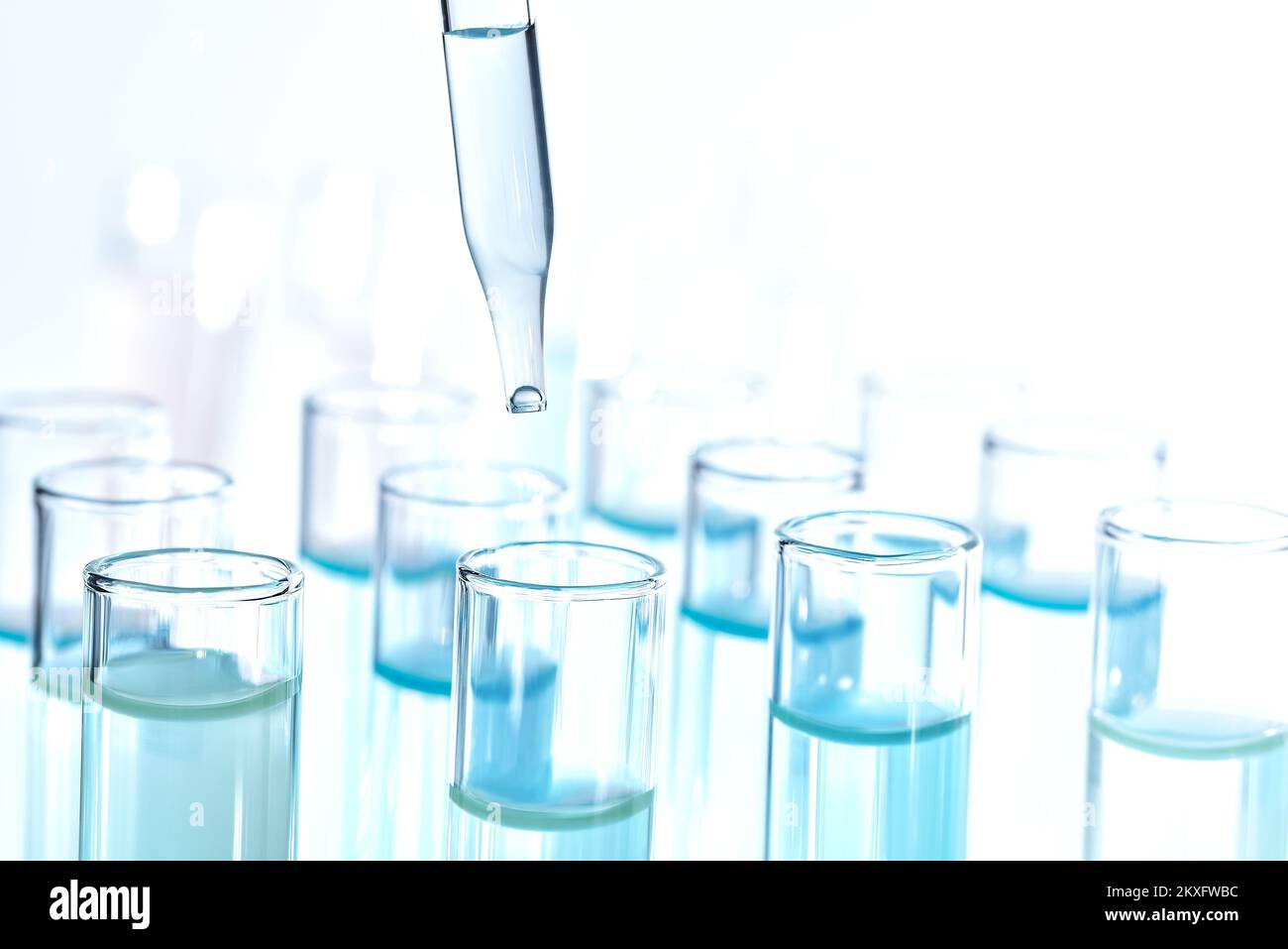 Laboratory glassware with dropper into test tube close up macro ...