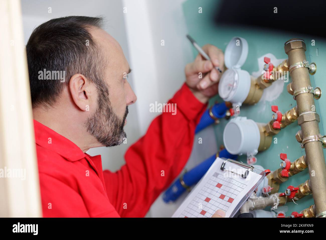 maintenance engineer checking technical data of heating system e Stock ...