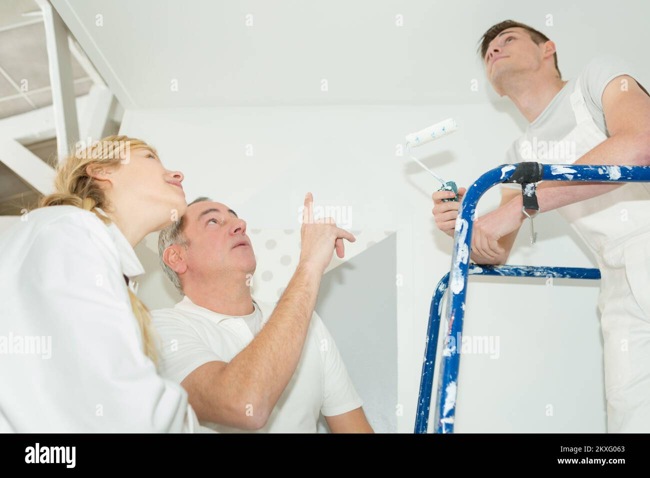 male apprentice painting a ceiling Stock Photo - Alamy