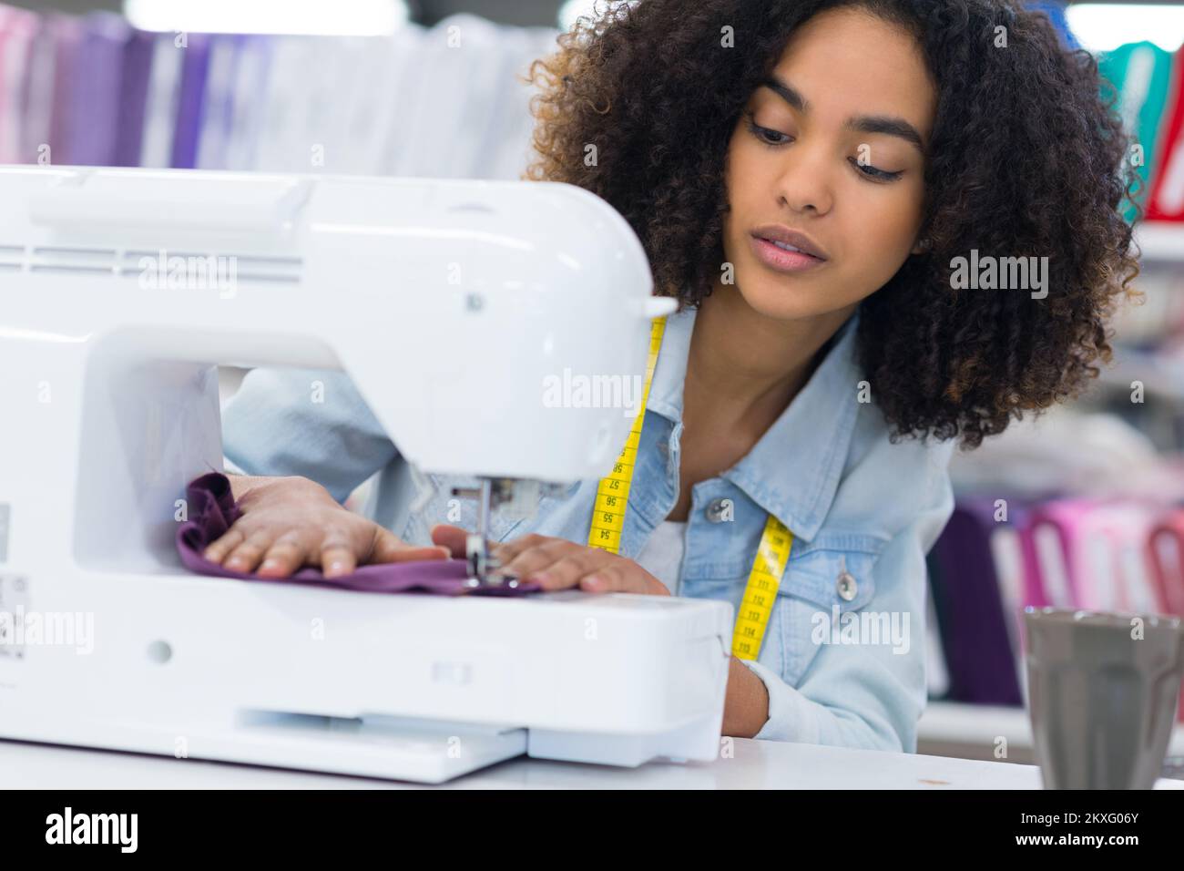 Girl seamstress working sewing machine hi-res stock photography and images - Alamy