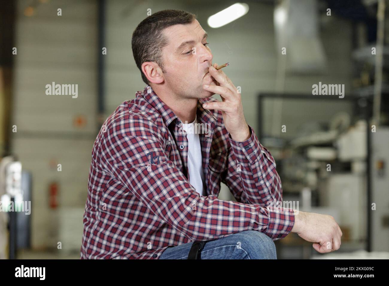 engineers male smoking e-cigarette in power plant Stock Photo - Alamy