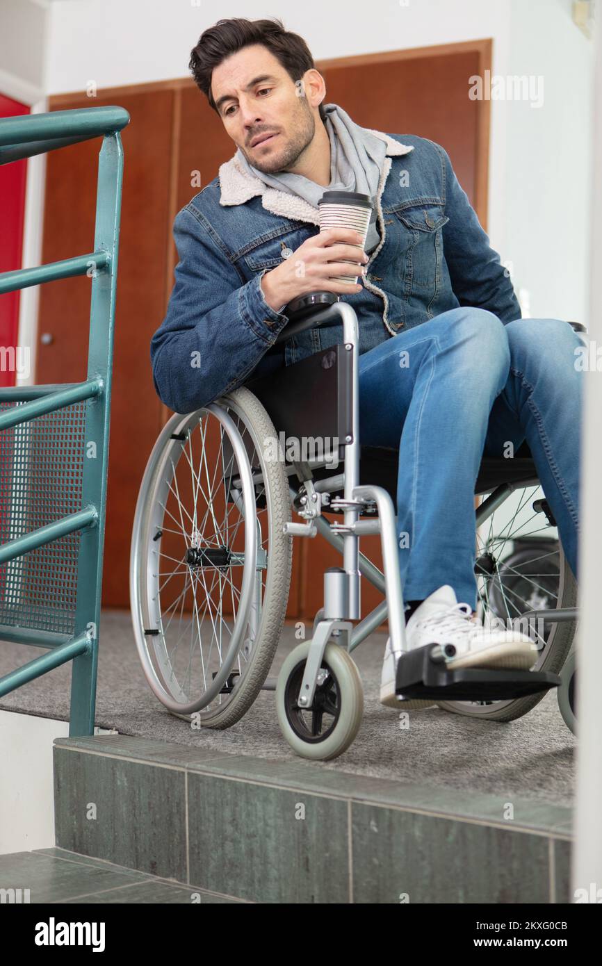 man on wheelchair trying to climb down the steps Stock Photo - Alamy