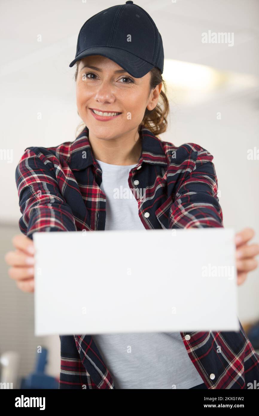 female worker holding blank advertising banner Stock Photo - Alamy