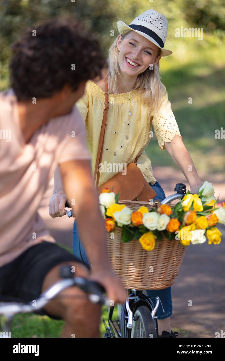 happy couple chasing each other on bike Stock Photo - Alamy