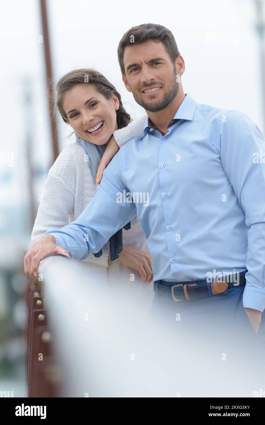 portrait of elegant couple holding handrail Stock Photo - Alamy