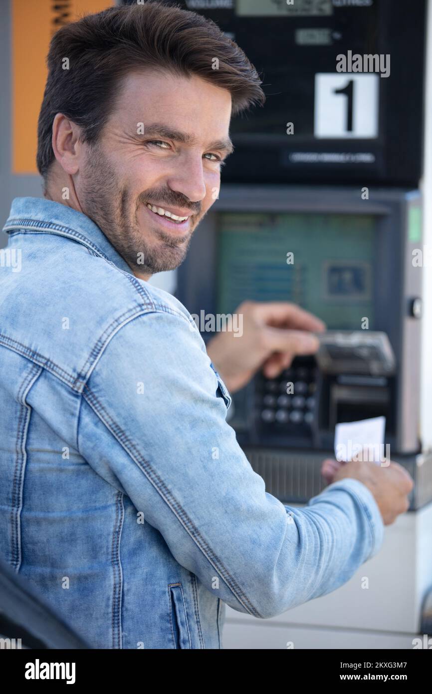 young man paying at gas station Stock Photo - Alamy