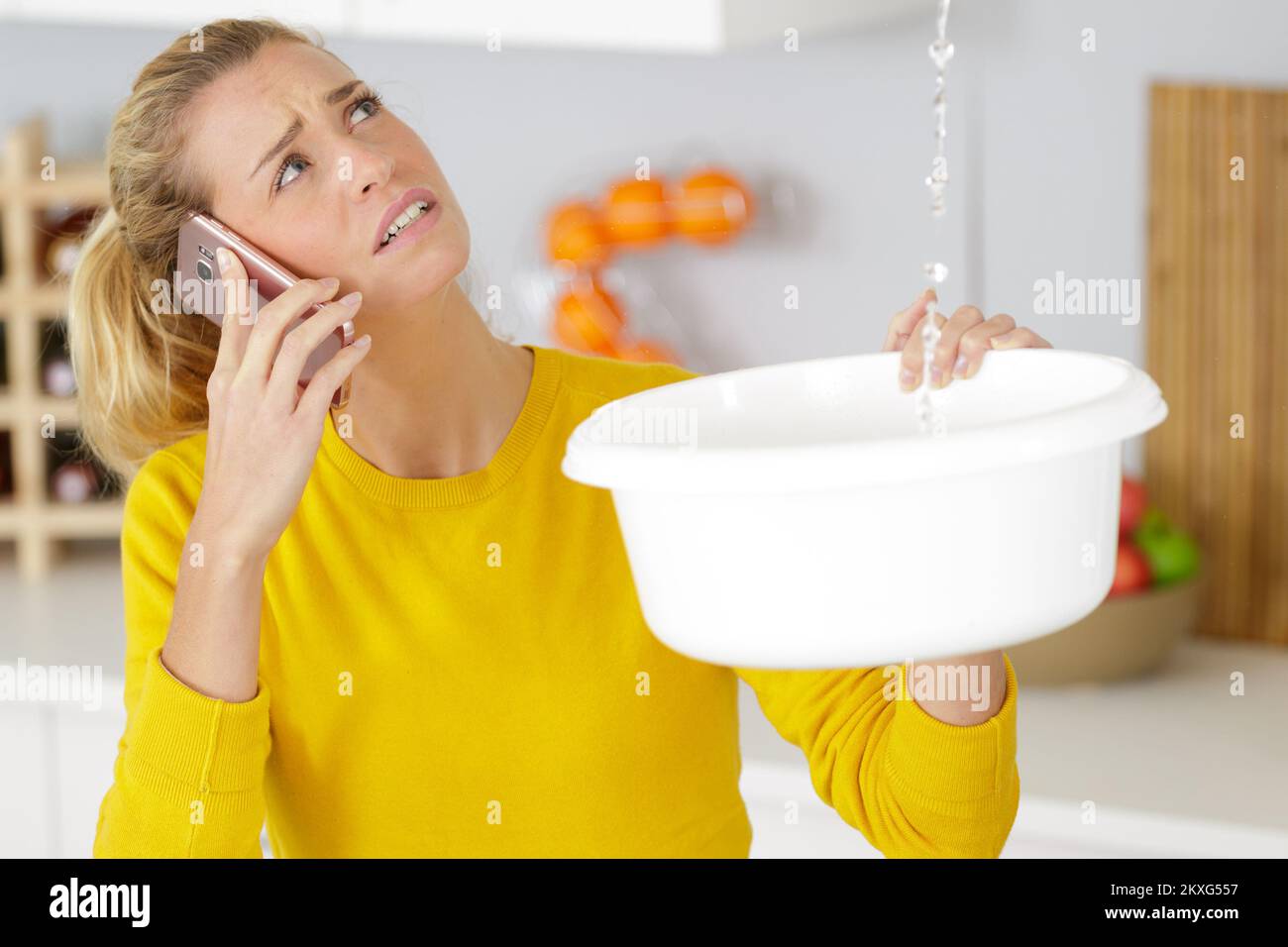 woman calling insurance for home leaks Stock Photo - Alamy