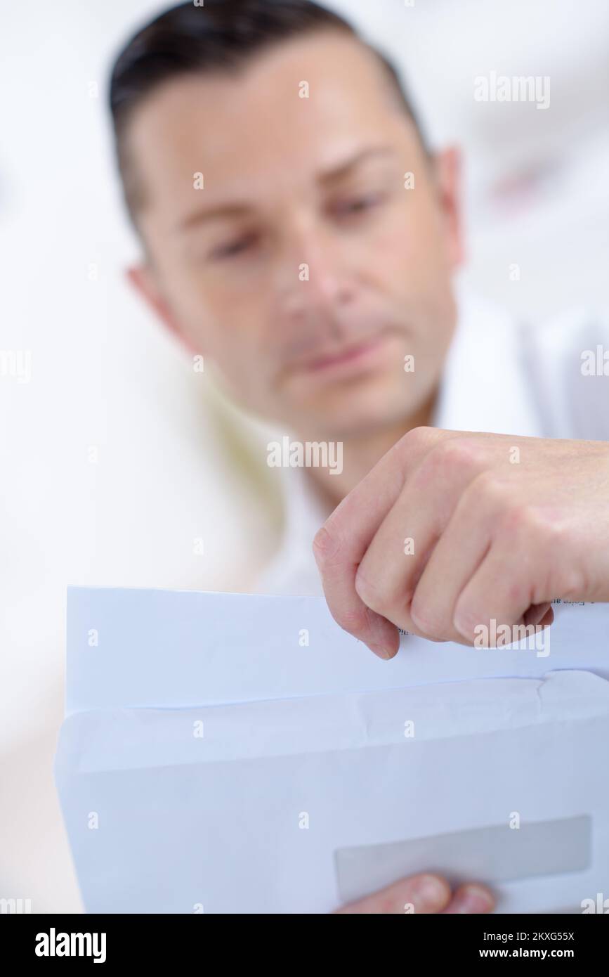 a man is opening an envelope Stock Photo - Alamy