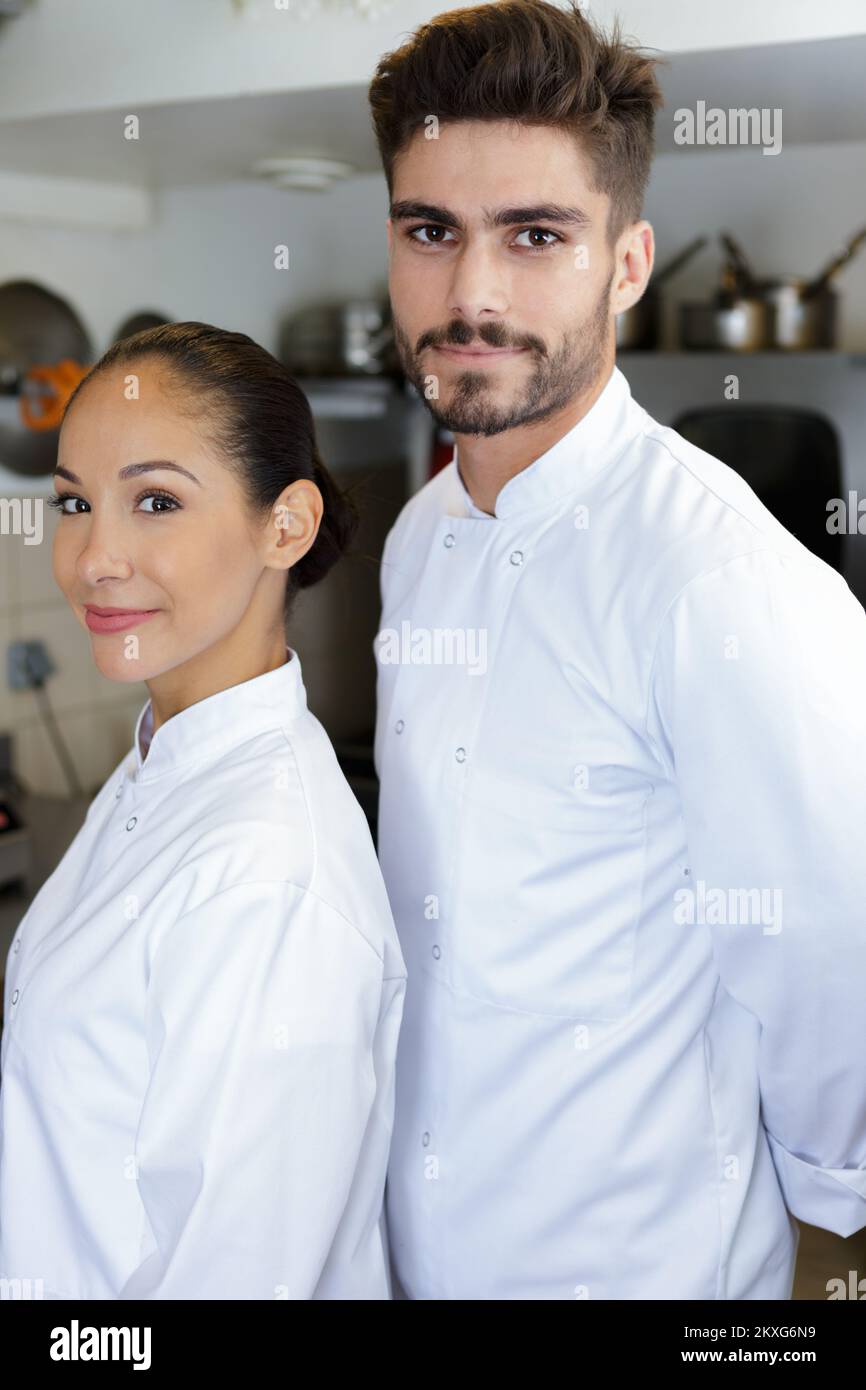 team of chefs posing in kitchen Stock Photo - Alamy