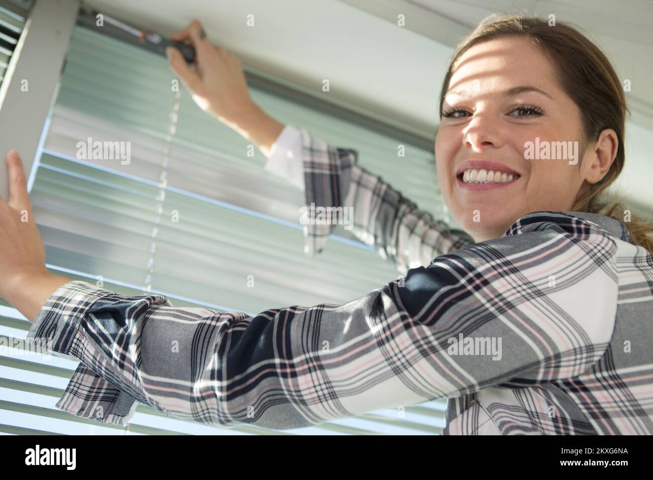 a woman opening blinds window Stock Photo - Alamy