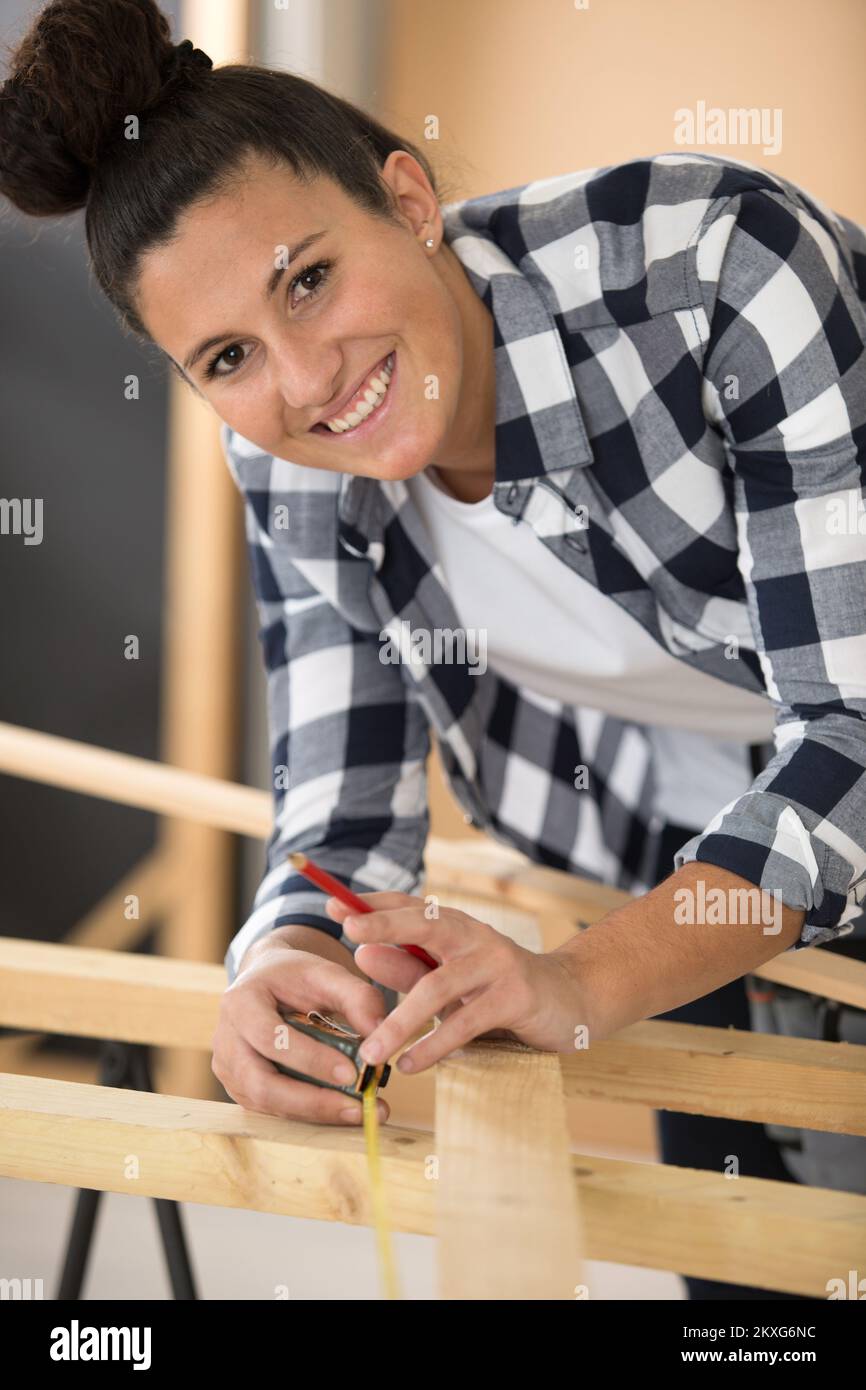 Female carpenter measuring wood hi-res stock photography and images - Alamy
