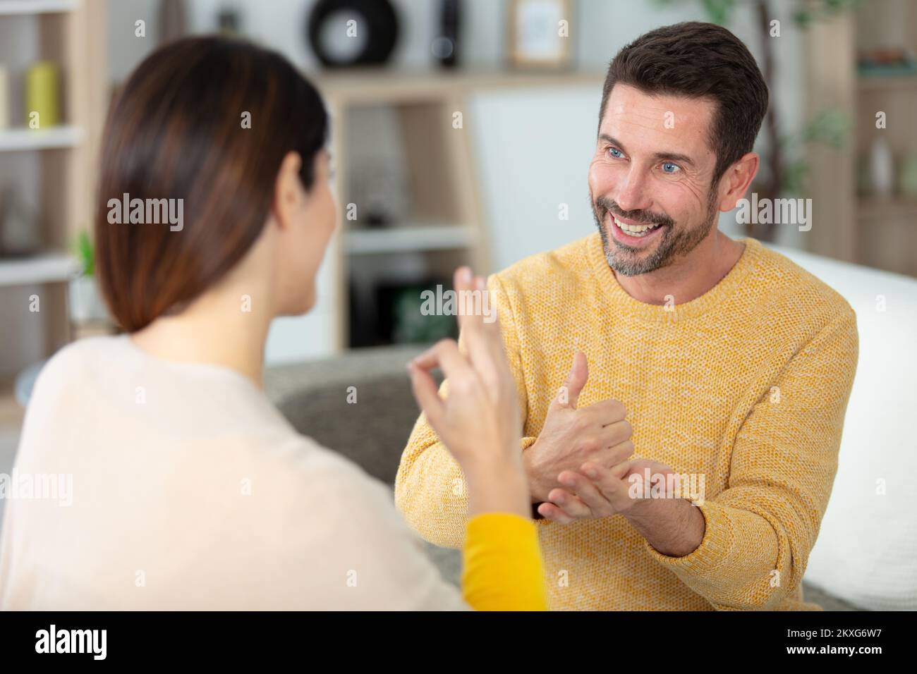 cheerful couple communicate by sign language Stock Photo - Alamy
