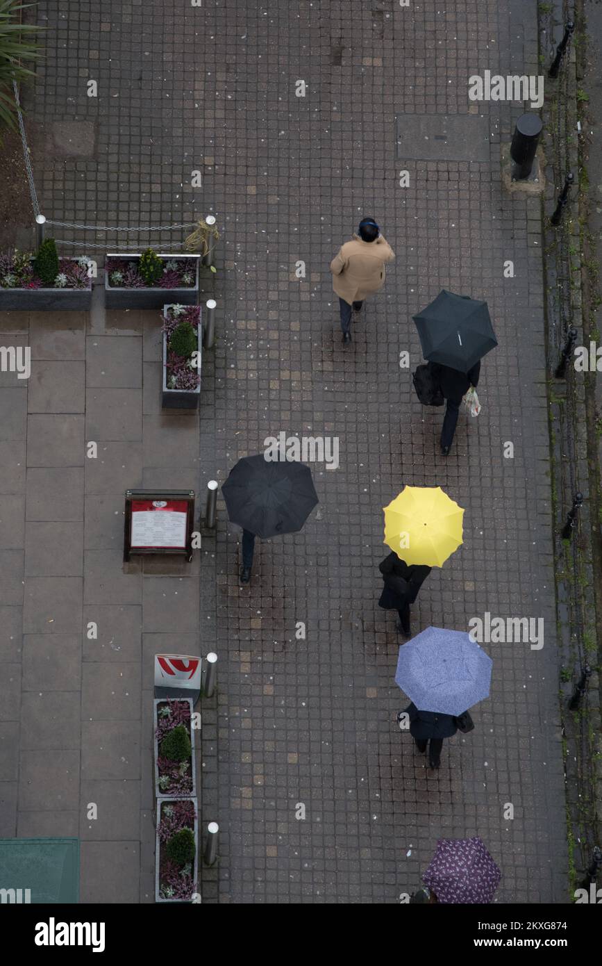 Group of unrecognised people with umbrella walking in the rain. Rush ...