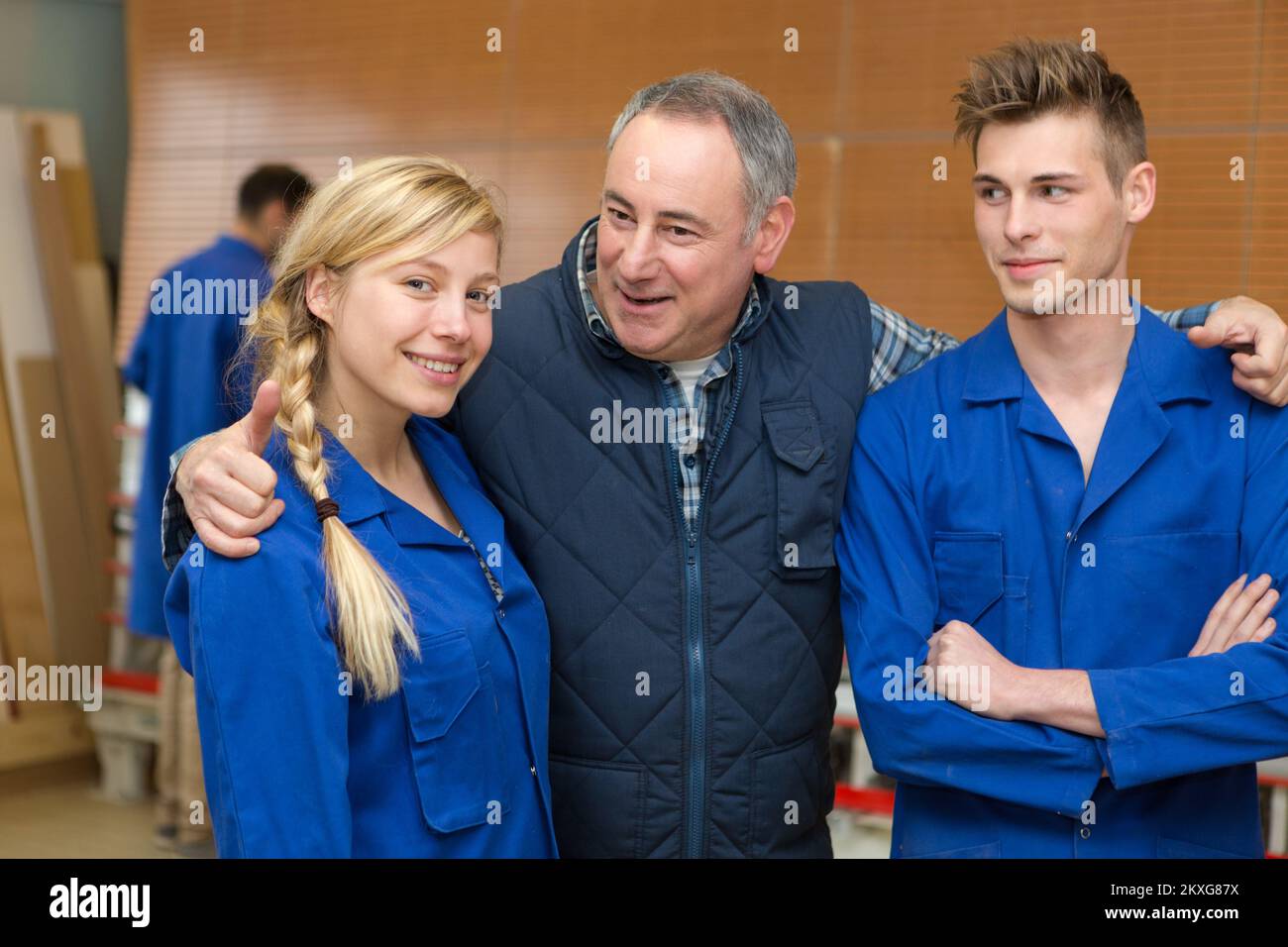 apprenticeship teacher happy with his students Stock Photo - Alamy