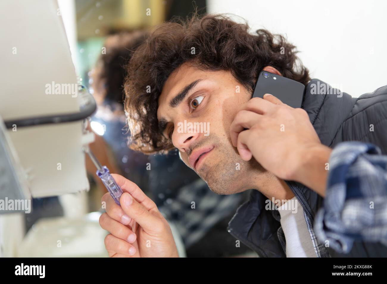 close view of serious handyman using a smartphone Stock Photo - Alamy
