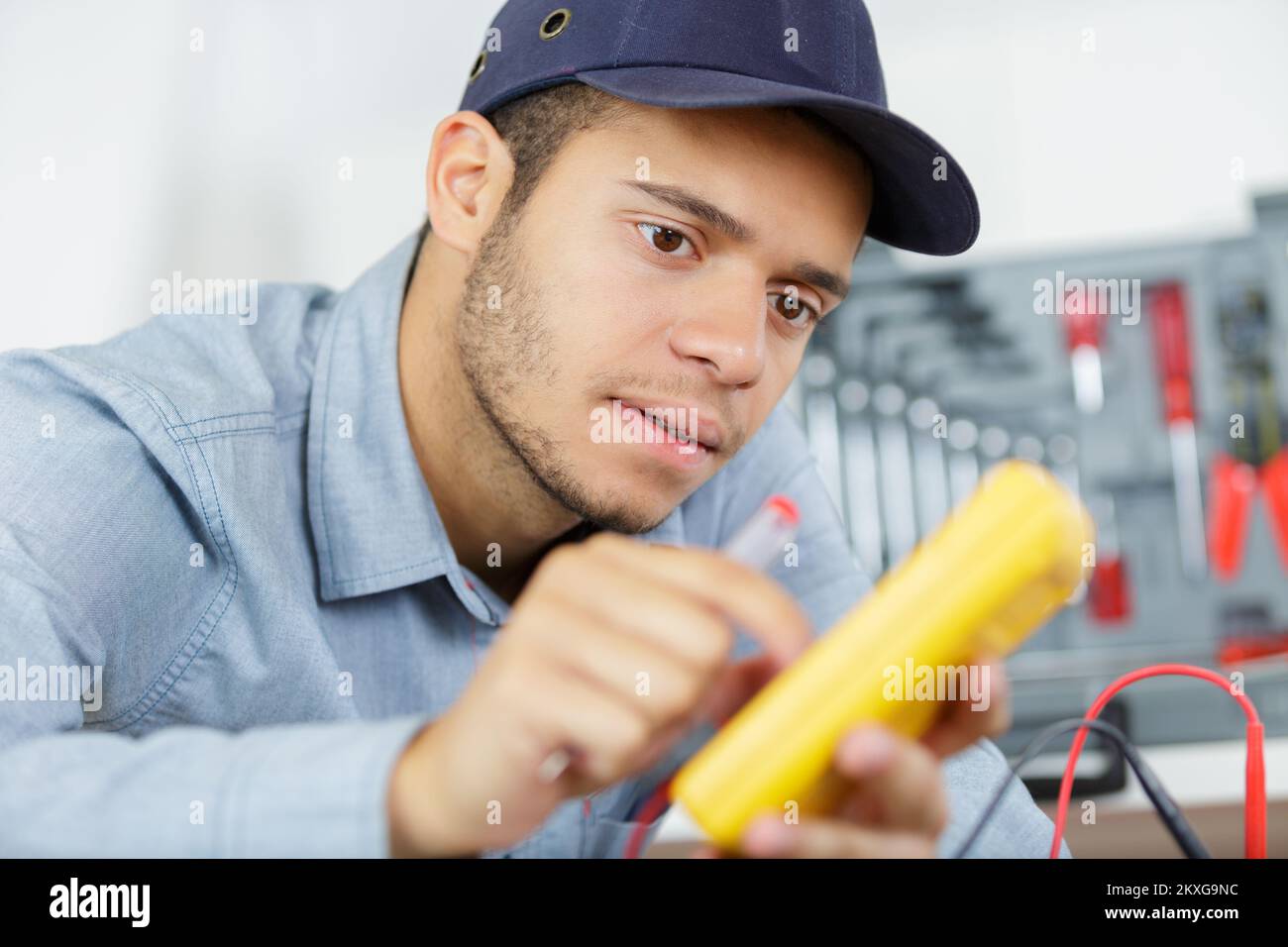 young electrician using a multi meter Stock Photo - Alamy