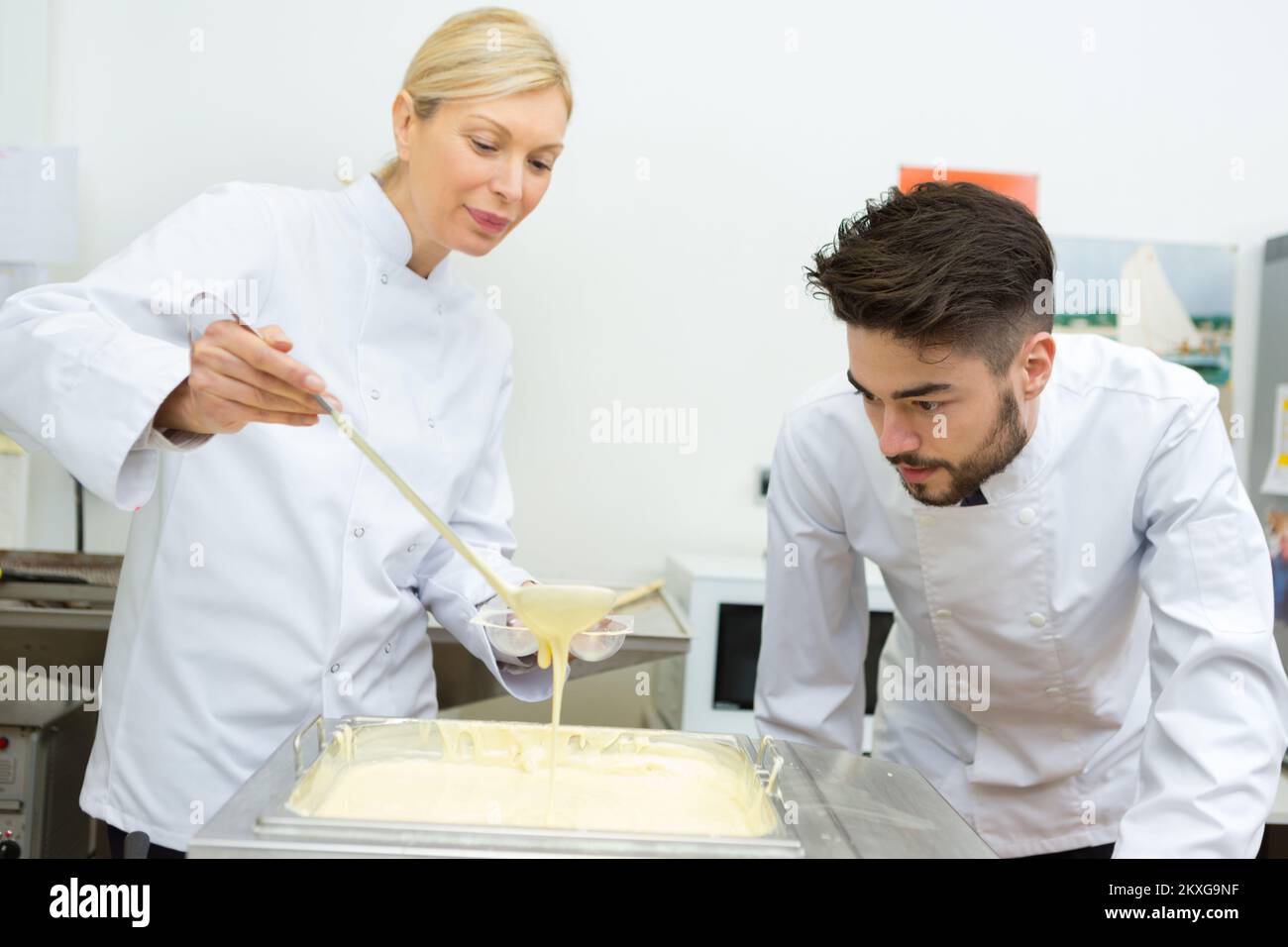 mature chef ladelling melted chocolate into mould Stock Photo - Alamy