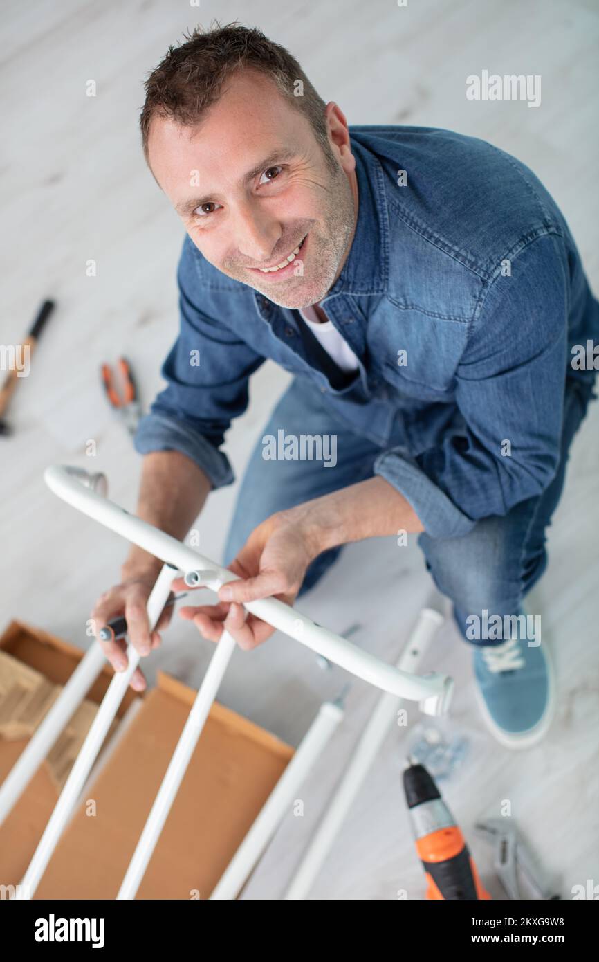 man assembling structure of metal bars Stock Photo - Alamy