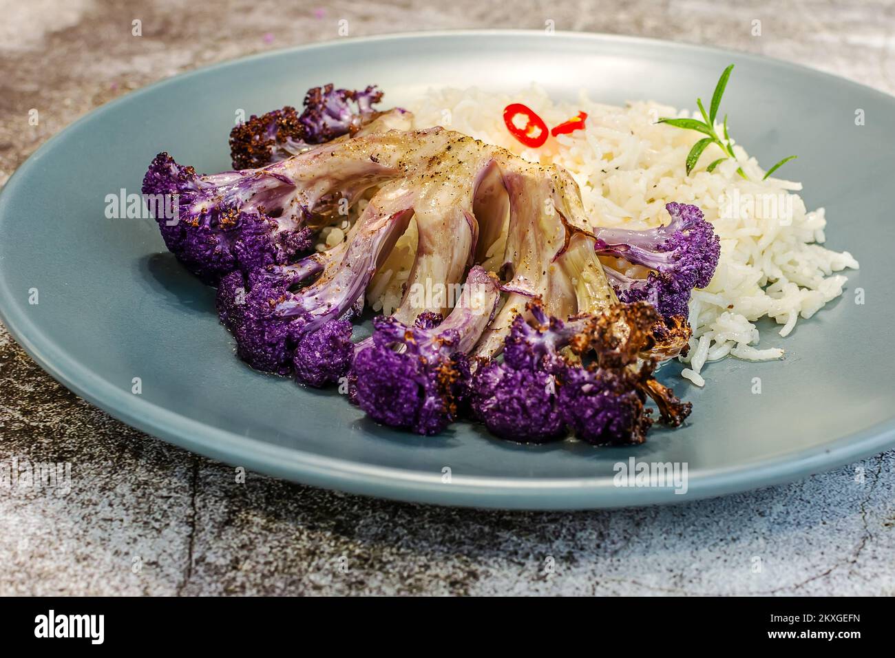 Purple cauliflower in a white baking dish in the oven Stock Photo - Alamy