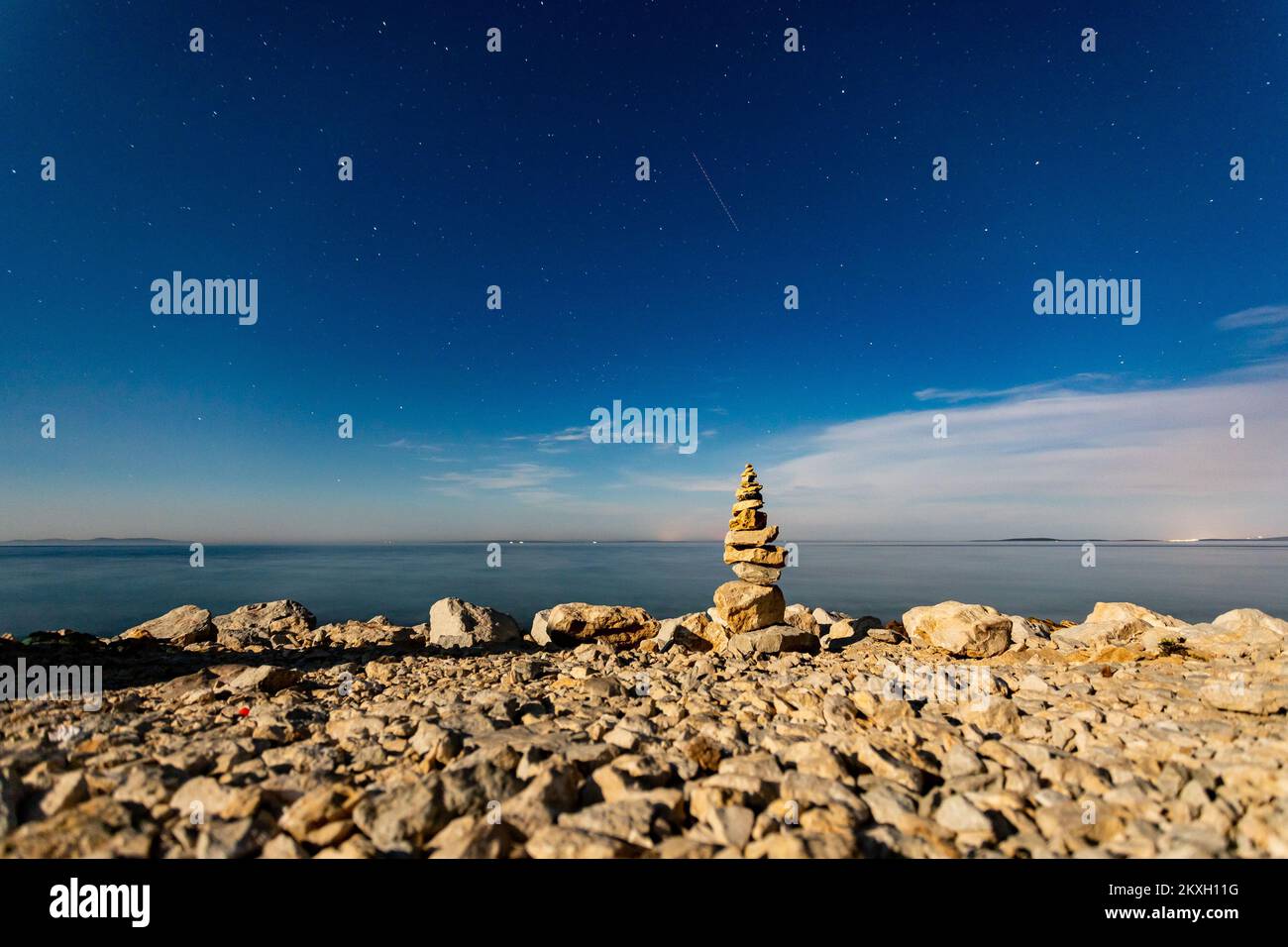 View of the night sky and sculptures of stacked stones,on Island of Vir ...