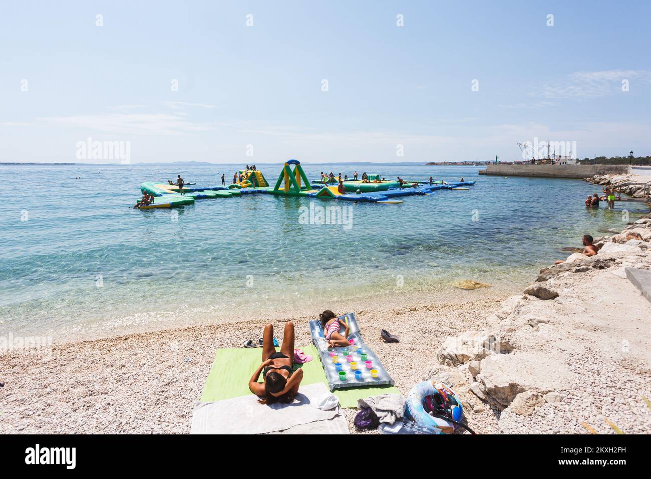 A large number of tourists can be seen enjoying a summer vacation on ...