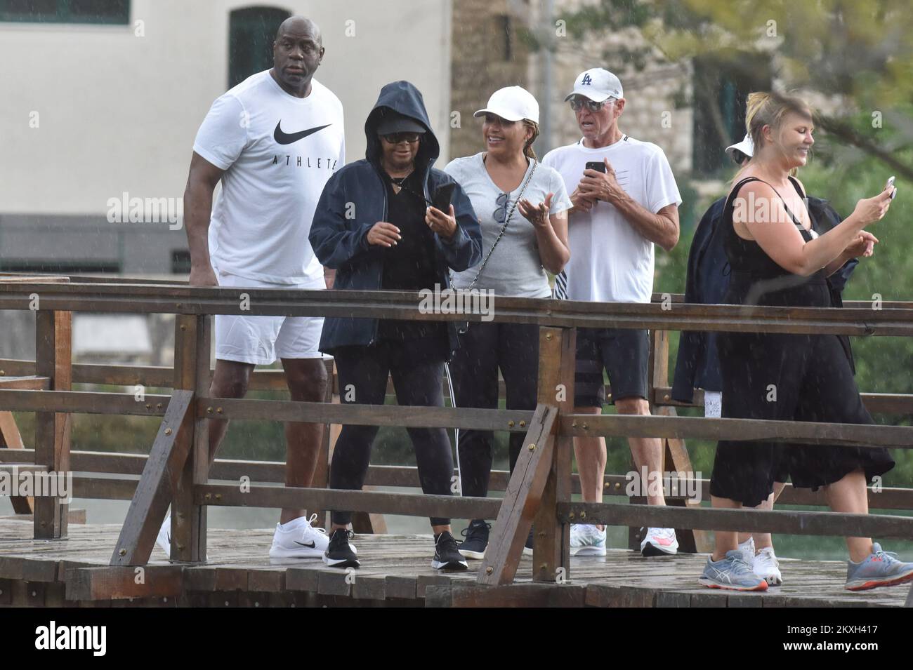 Magic Johnson, a basketball legend, in the company of his friend and ...