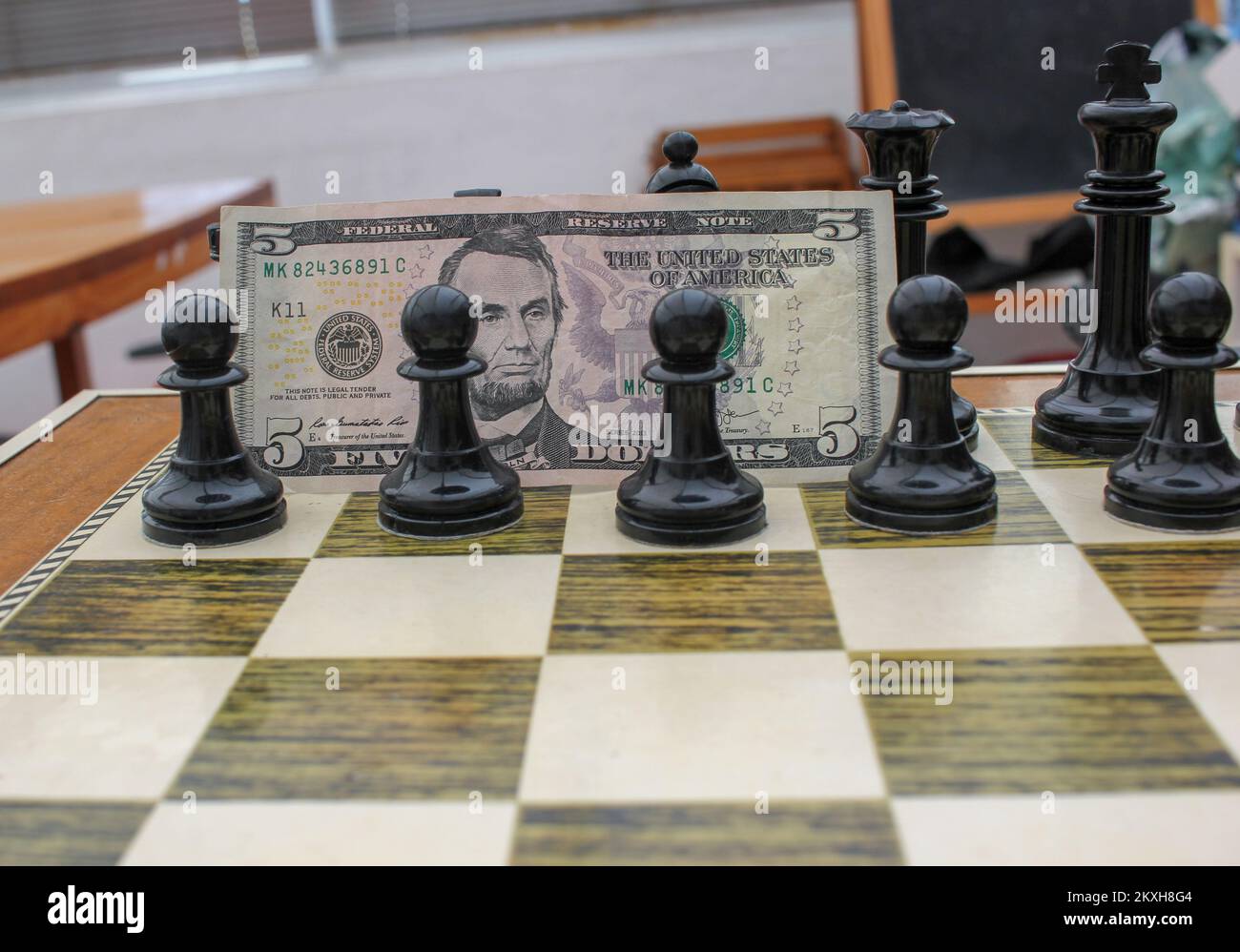 dollar bill among black chess pieces in an inflation scenario Stock ...